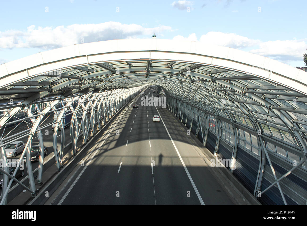 Cars on the road in the sound-absorbing tunnel. Metal structure and ...
