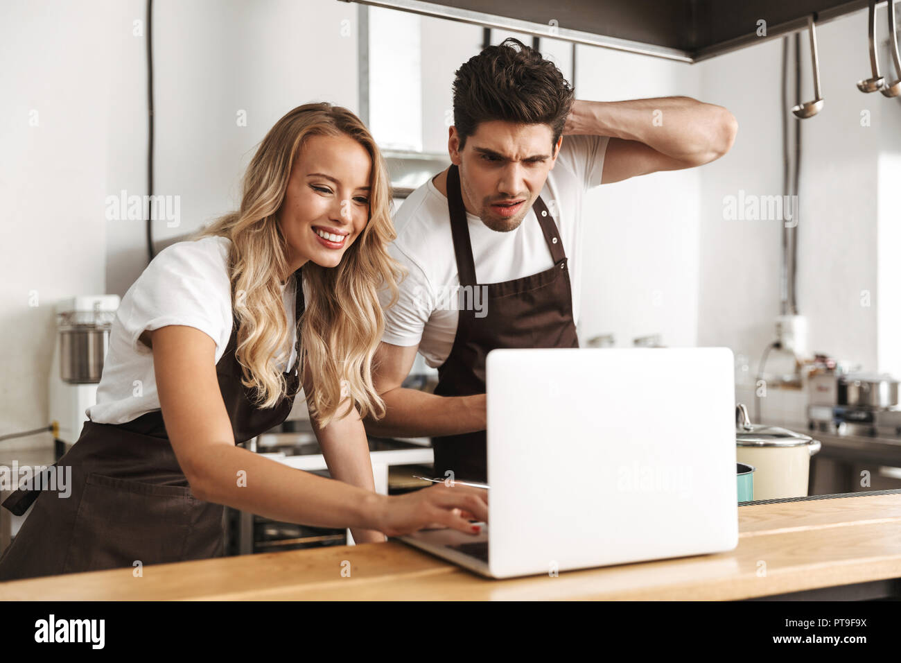 Image of cheerful emotional young friends loving couple chefs on the ...