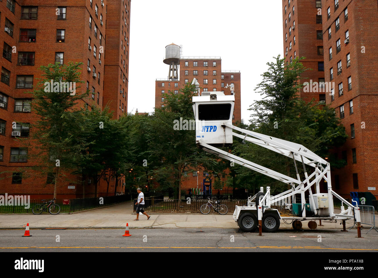 A person walks by a NYPD SkyWatch Surveillance Tower located outside ...
