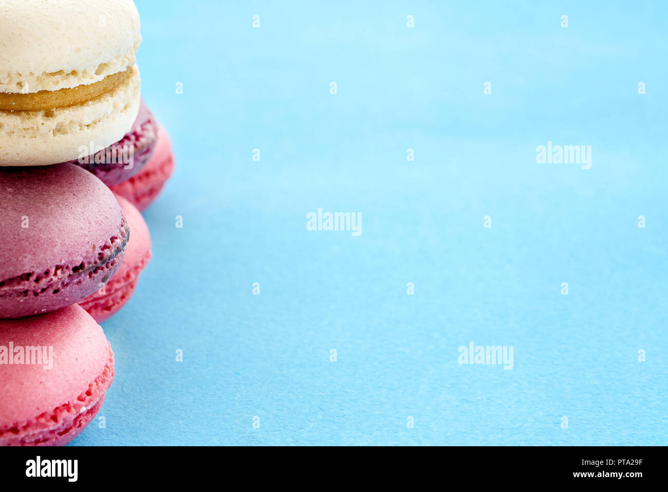 French Macarons on a blue background. Trendy dessert. Sweet cakes Stock ...