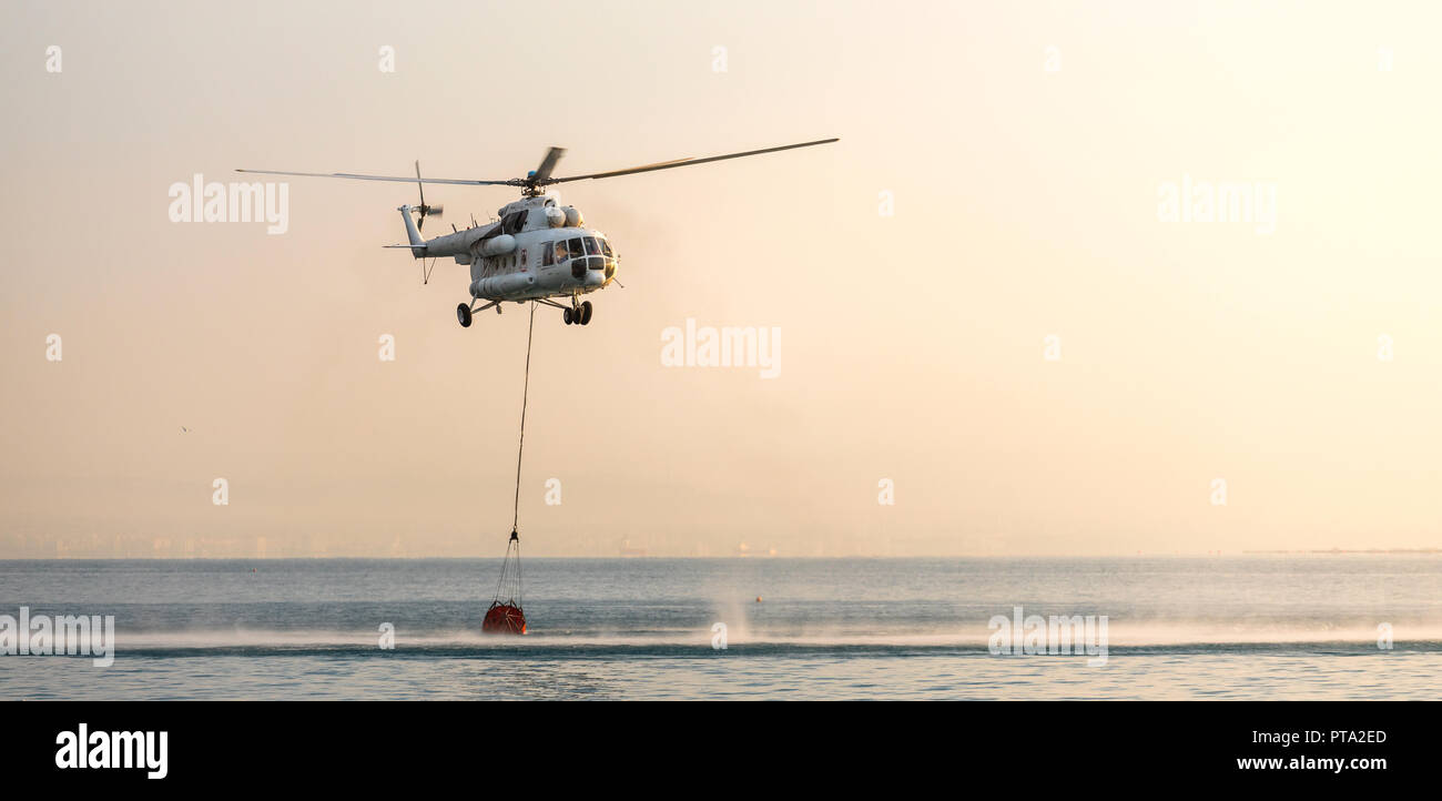 Fire air equipment works to eliminate a forest fire in the mountains in ...