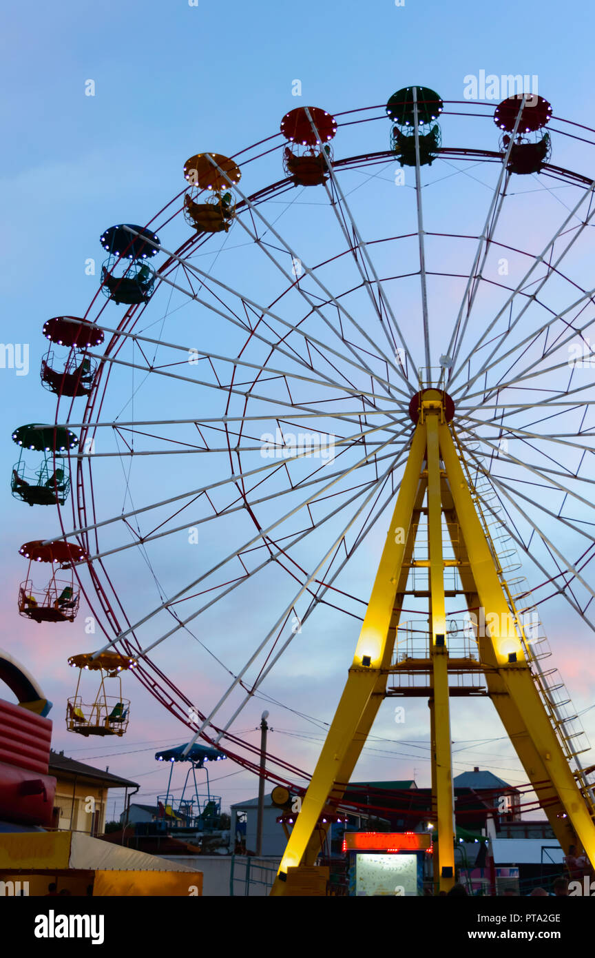 Amusement park on the background of the sunset. Ferris wheel Stock ...