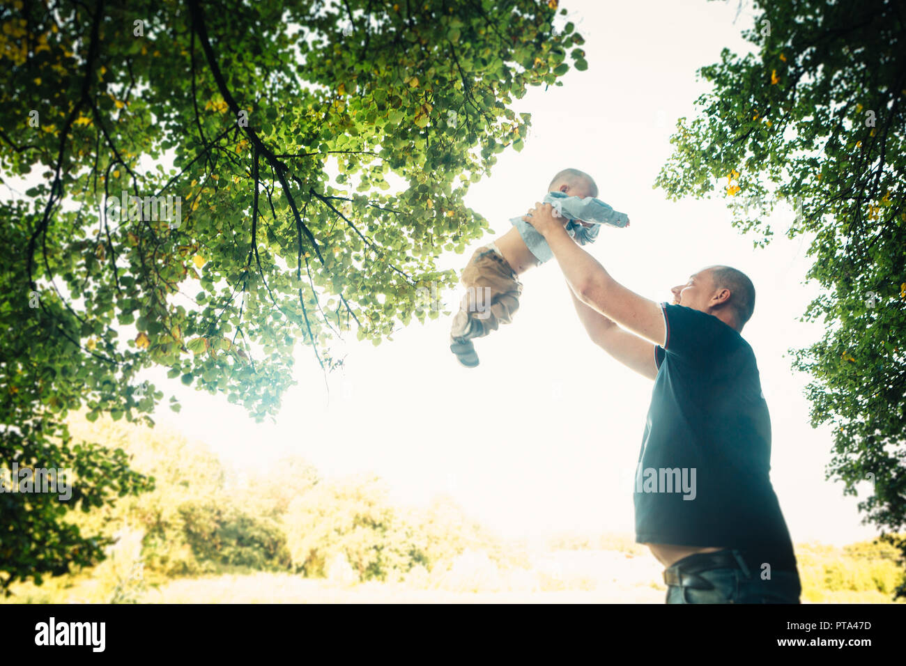 happy dad and baby on nature background Stock Photo - Alamy