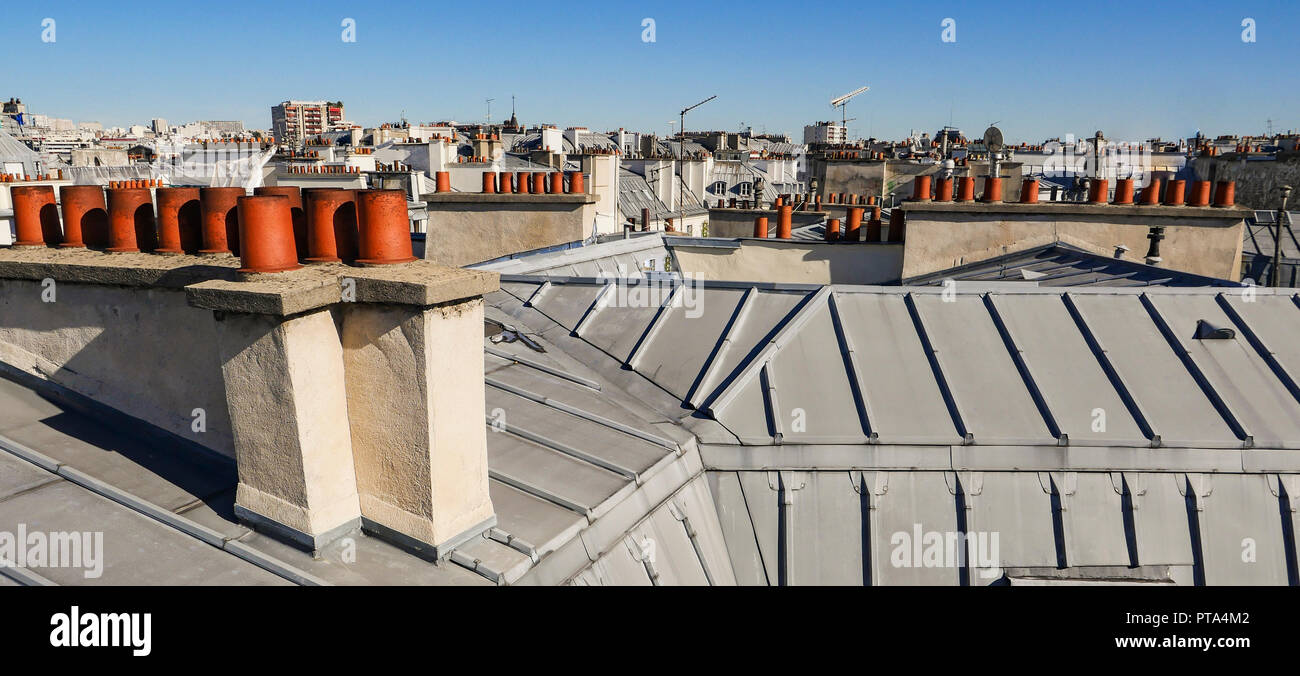 The roofs of Paris and its chimneys under a clouds sky, France, Europe ...