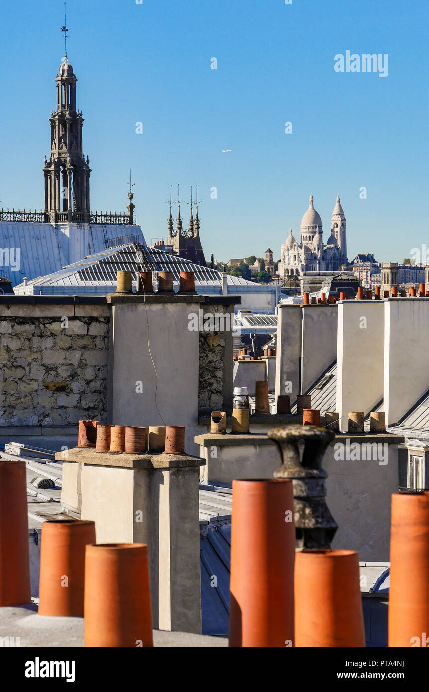 The roofs of Paris and its chimneys under a clouds sky, France, Europe ...