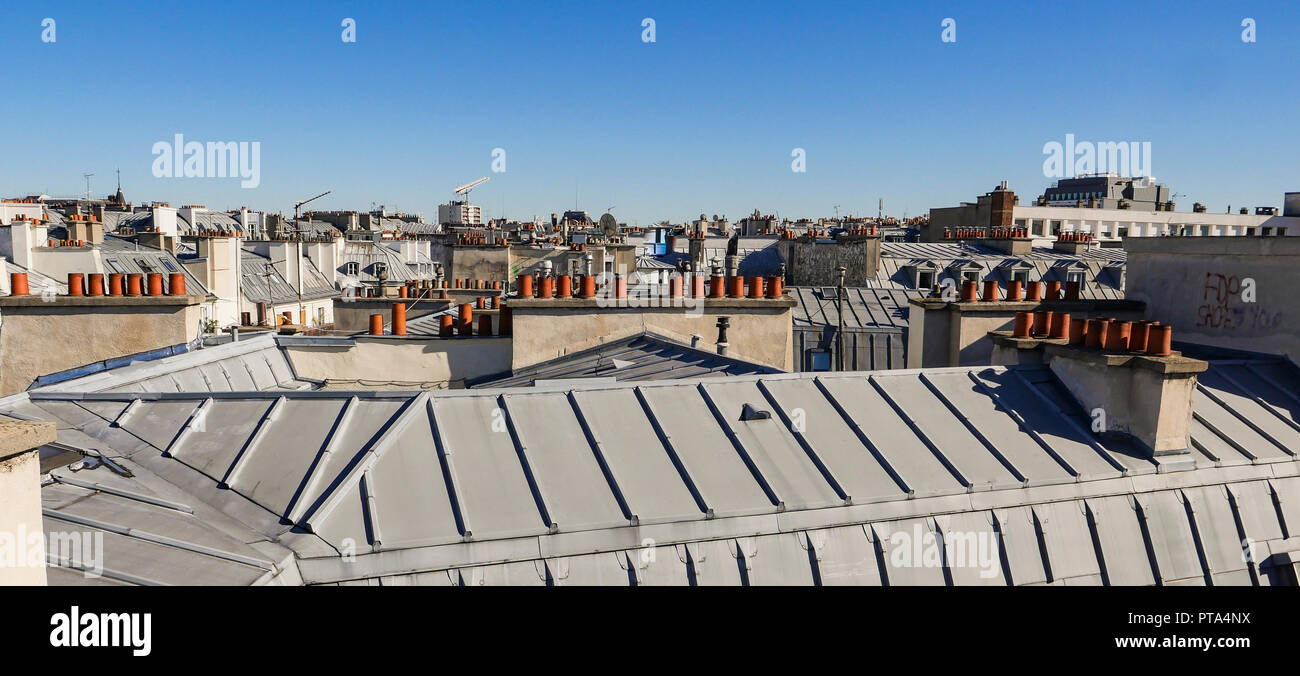 The roofs of Paris and its chimneys under a clouds sky, France, Europe ...