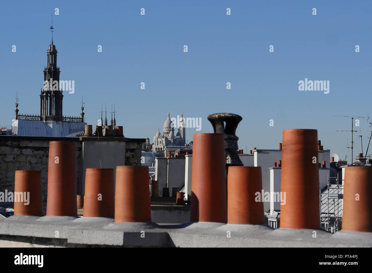 The roofs of Paris and its chimneys under a clouds sky, France, Europe ...