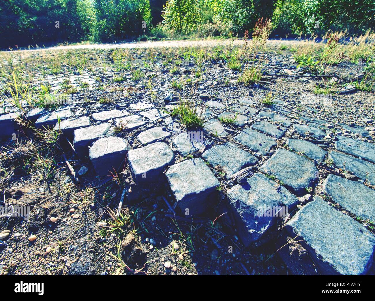 Ruined old cobble stone way. Paving Stones Road. Crawl destroyed urban ...