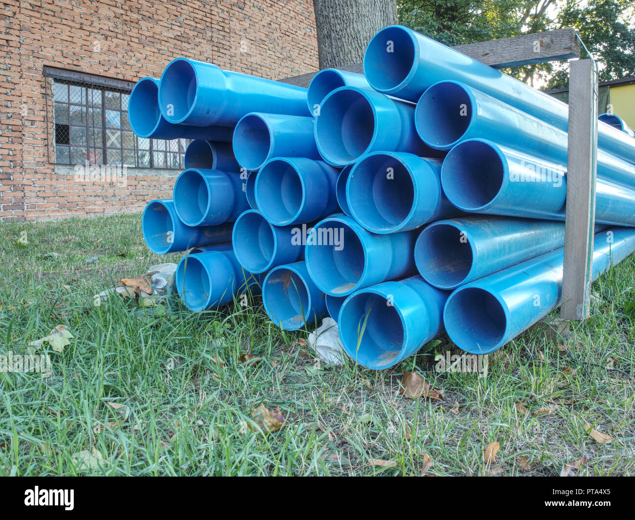Bundles of blue plastic pipes for water transport. Pipe batch ...