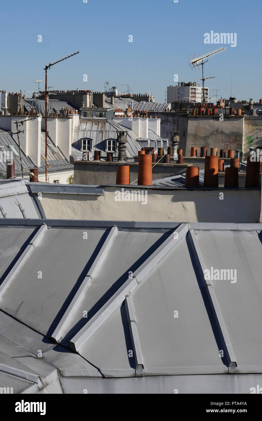 The roofs of Paris and its chimneys under a clouds sky, France, Europe ...