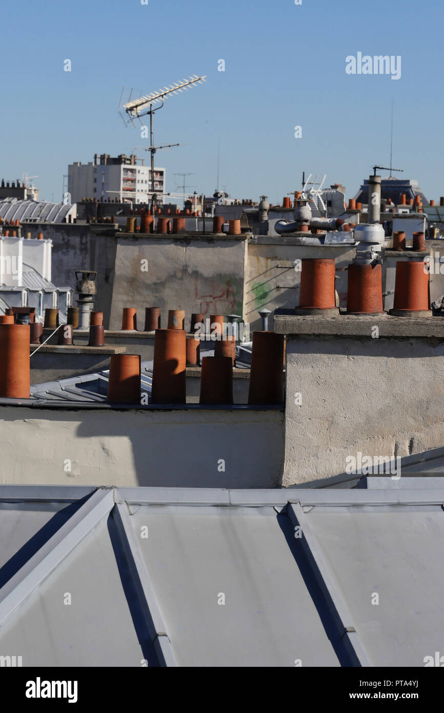 The roofs of Paris and its chimneys under a clouds sky, France, Europe ...