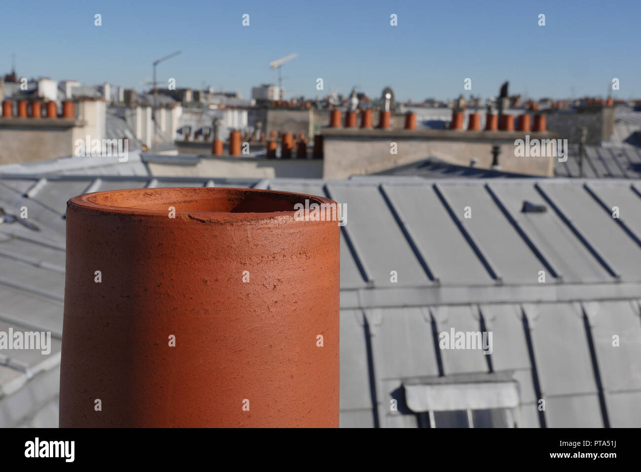 The roofs of Paris and its chimneys under a clouds sky, France, Europe ...