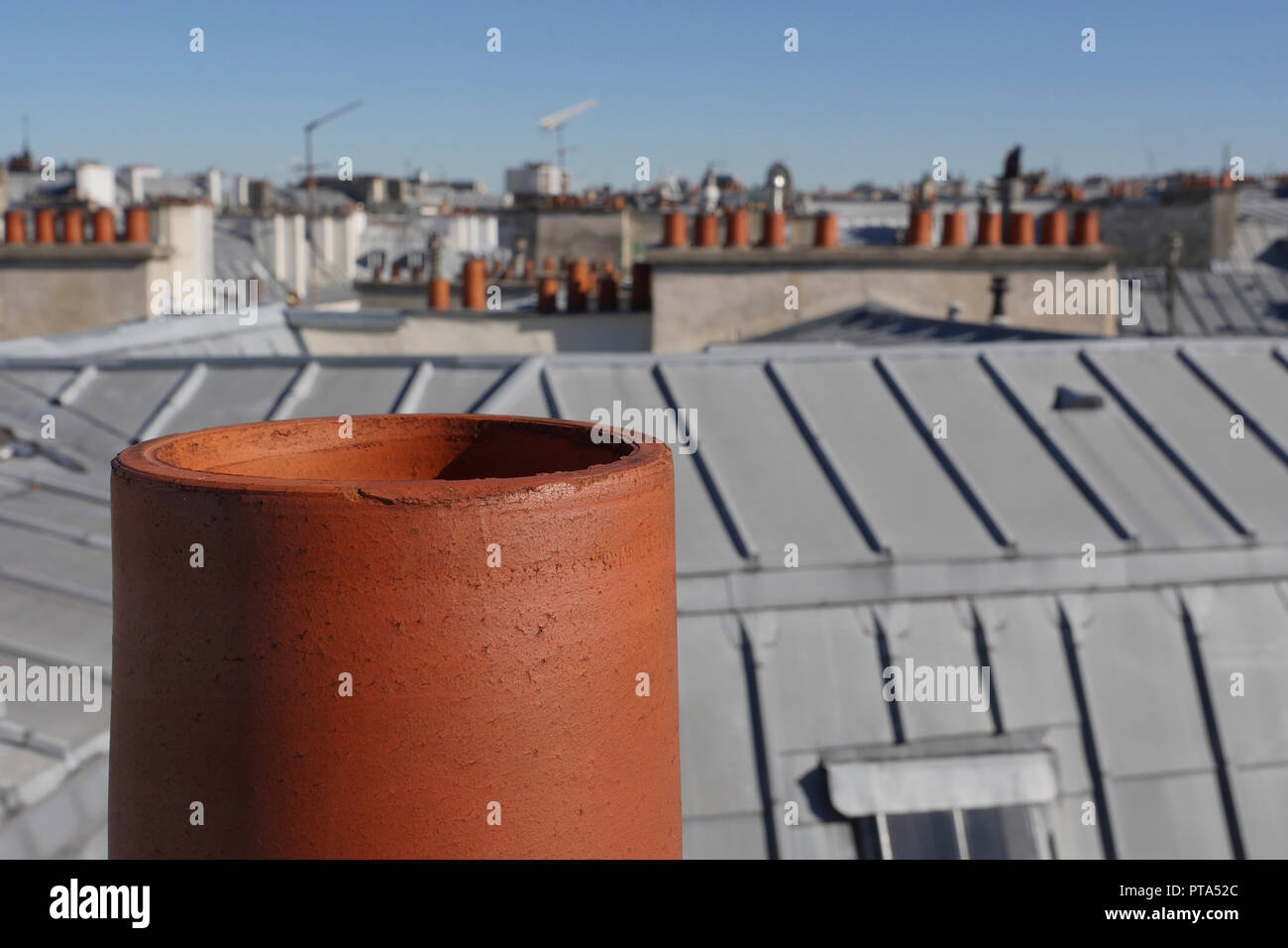The roofs of Paris and its chimneys under a clouds sky, France, Europe ...