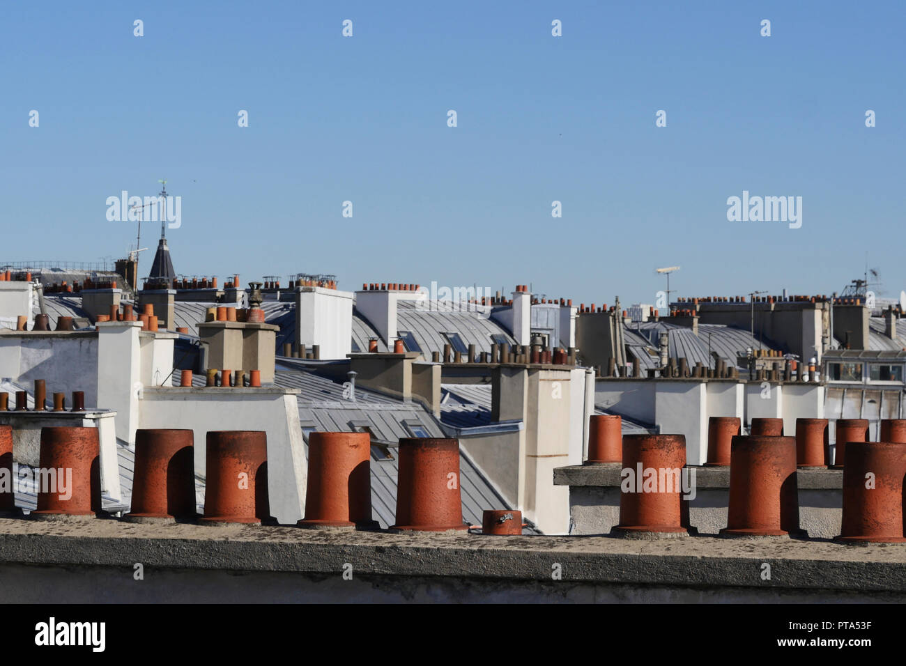 The roofs of Paris and its chimneys under a clouds sky, France, Europe ...