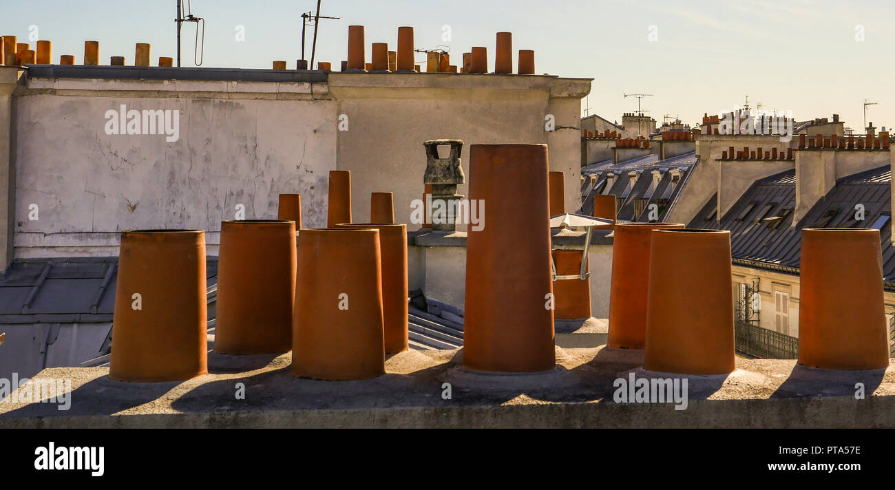 The roofs of Paris and its chimneys under a clouds sky, France, Europe ...