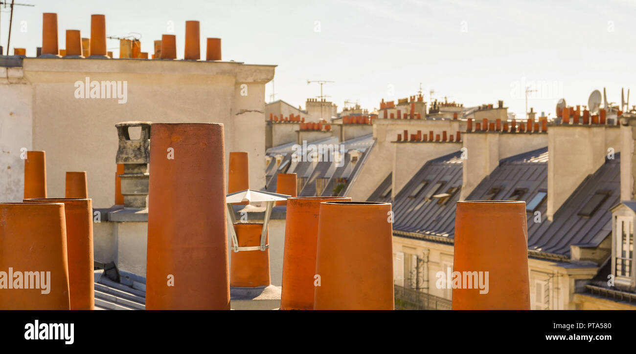 The roofs of Paris and its chimneys under a clouds sky, France, Europe ...
