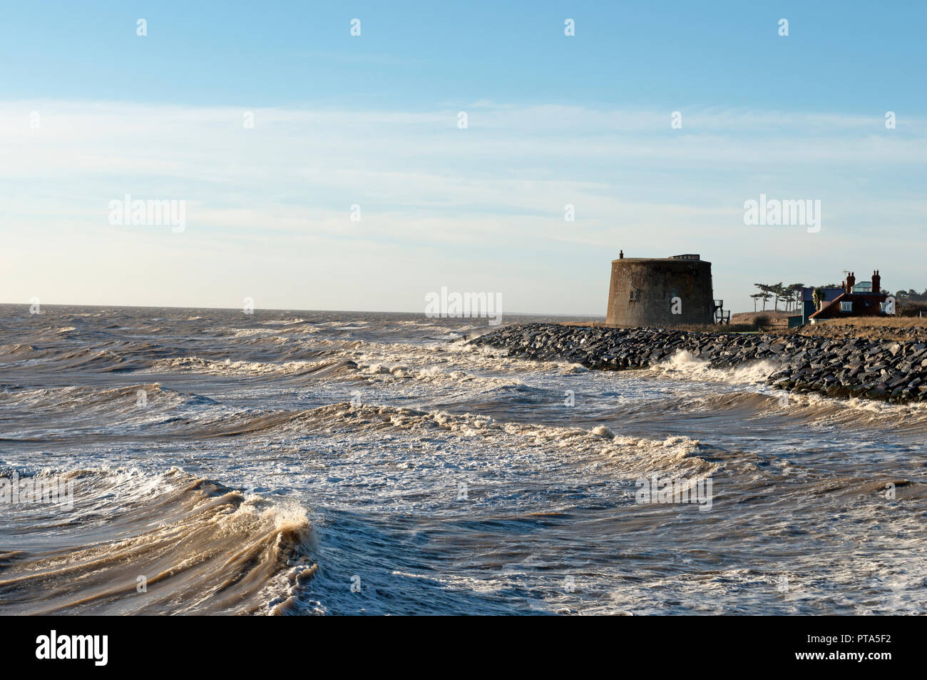 Rock armour protecting an historic Martello Tower from coastal erosion ...