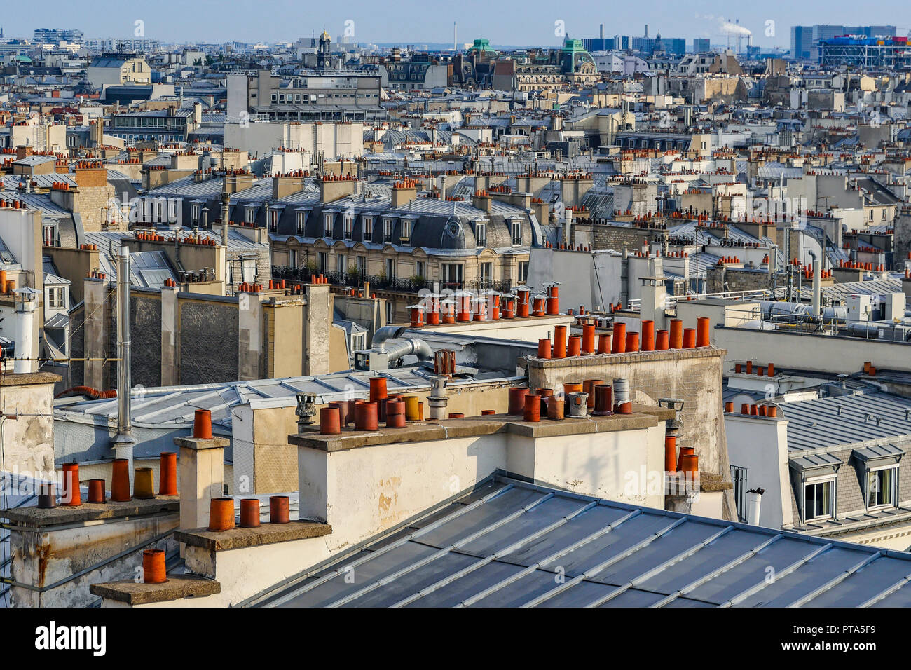 The roofs of Paris and its chimneys under a clouds sky, France, Europe ...