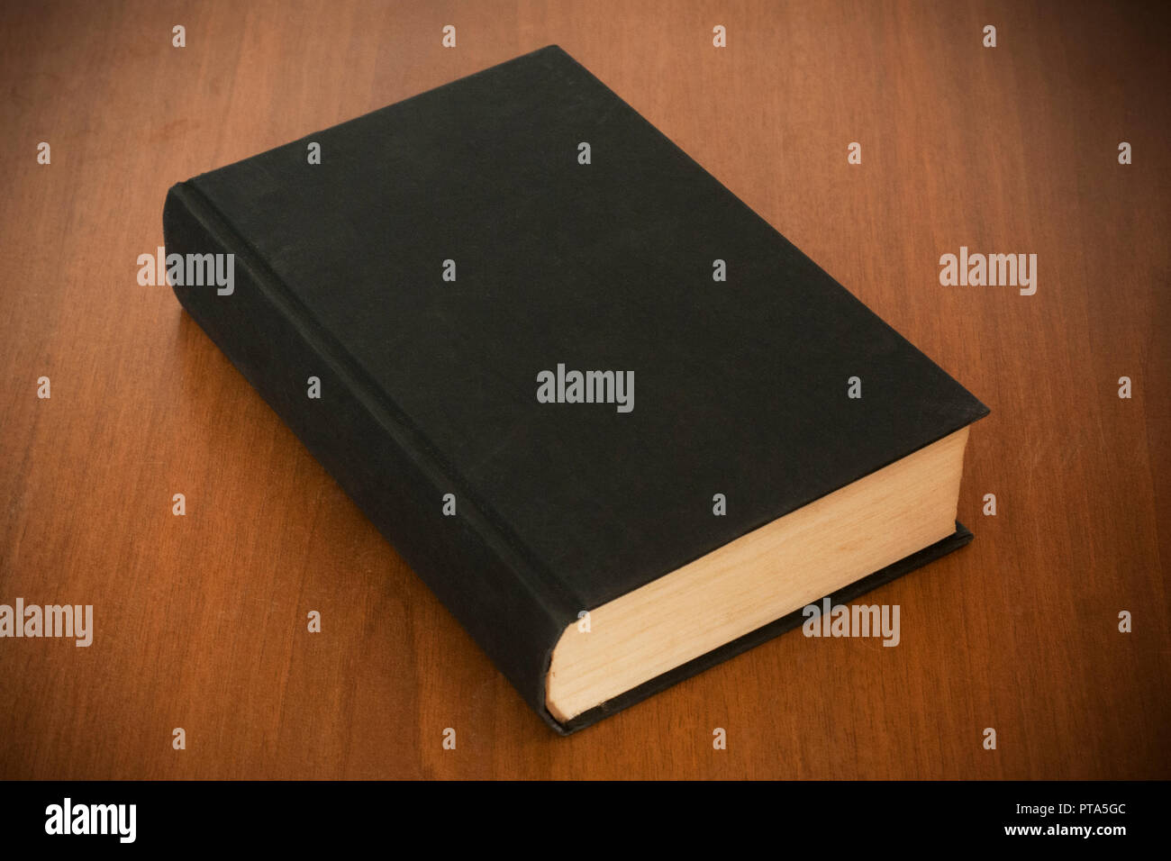 Blank old black book on wooden table ready for mockup or cover ...