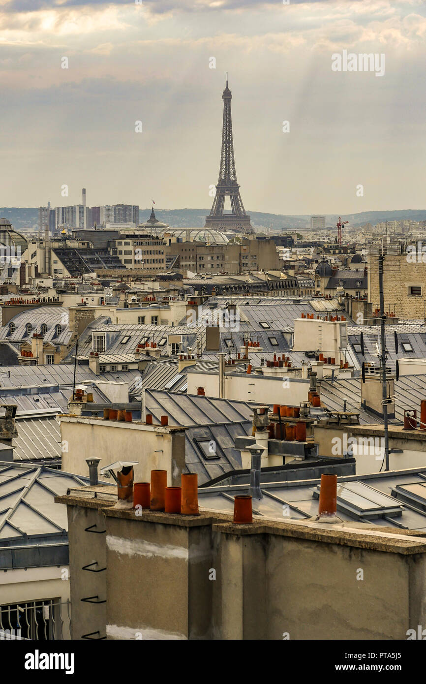 The roofs of Paris and its chimneys under a clouds sky, France, Europe ...