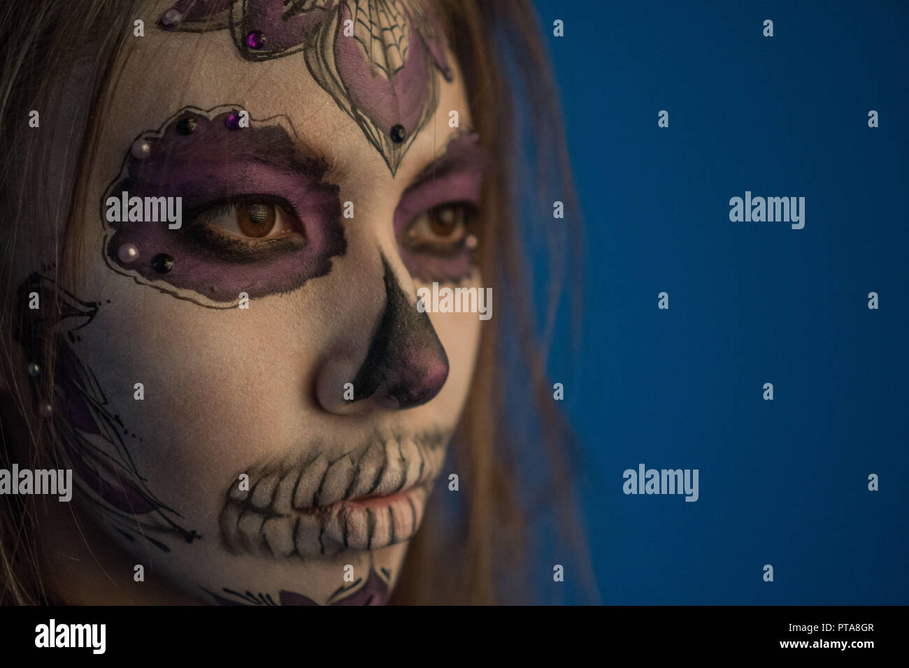 Close-up portrait of a girl with a dead man's make-up for Halloween ...