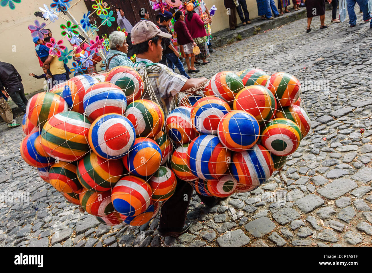 Antigua, Guatemala - Mar 1, 2015: Street sellers follow Lent procession ...