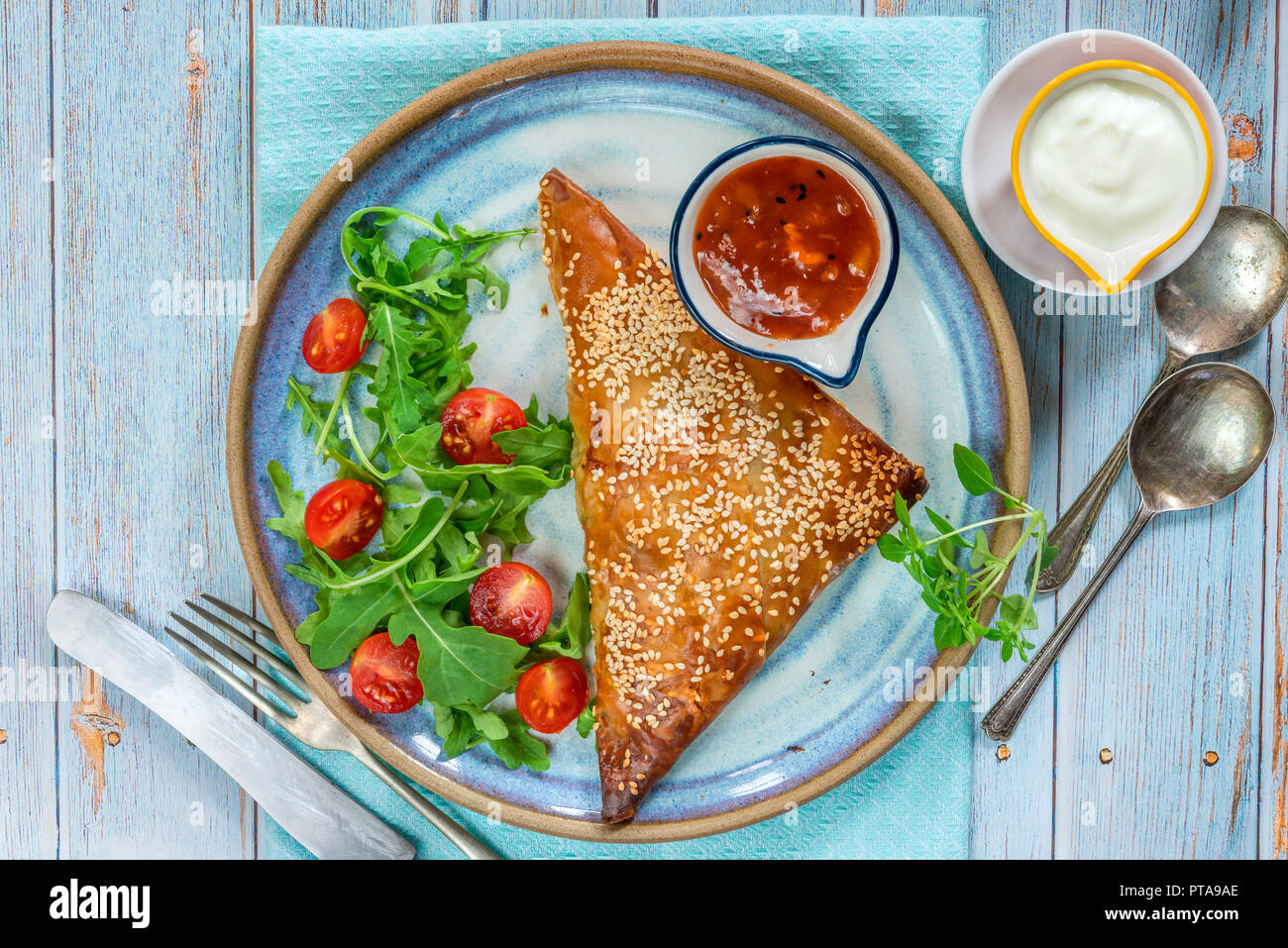 Giant chicken samosas with mango chutney and fresh salad, sprinkled ...
