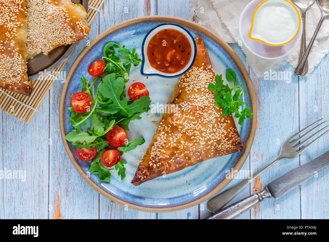 Giant chicken samosas with mango chutney and fresh salad, sprinkled ...