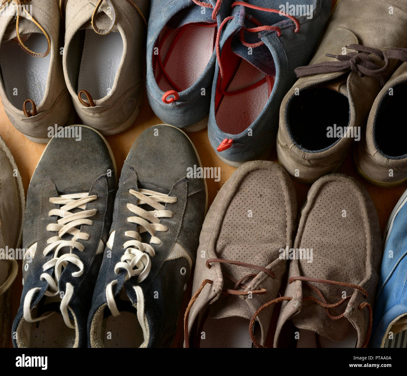 pile of men's shoes on wooden table - closeup Stock Photo - Alamy