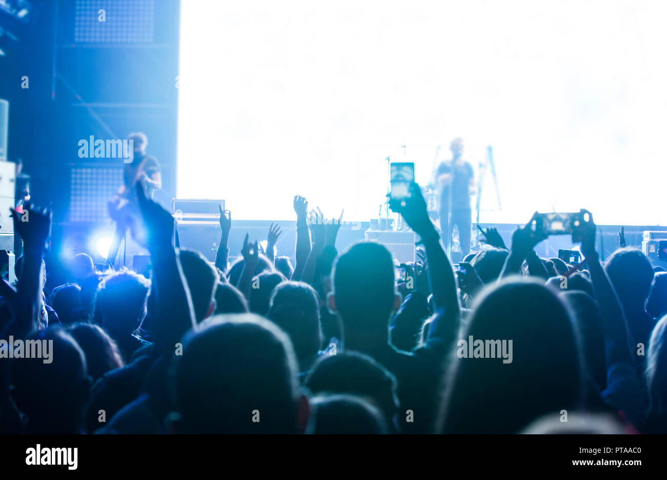 Crowd at concert - Cheering crowd in bright colorful stage lights Stock ...