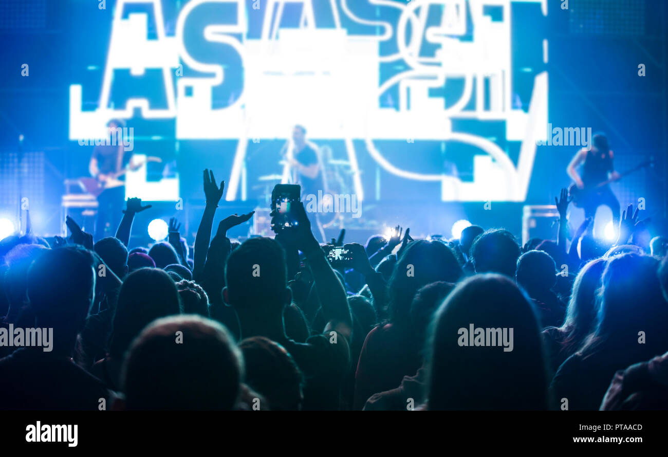 Crowd at concert - Cheering crowd in bright colorful stage lights Stock ...