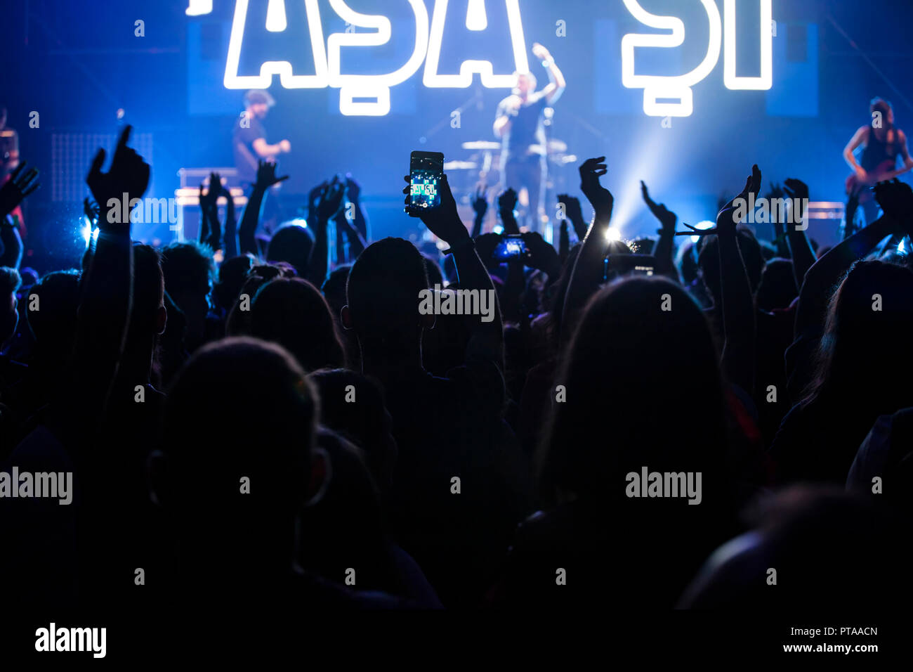 Crowd at concert - Cheering crowd in bright colorful stage lights Stock ...