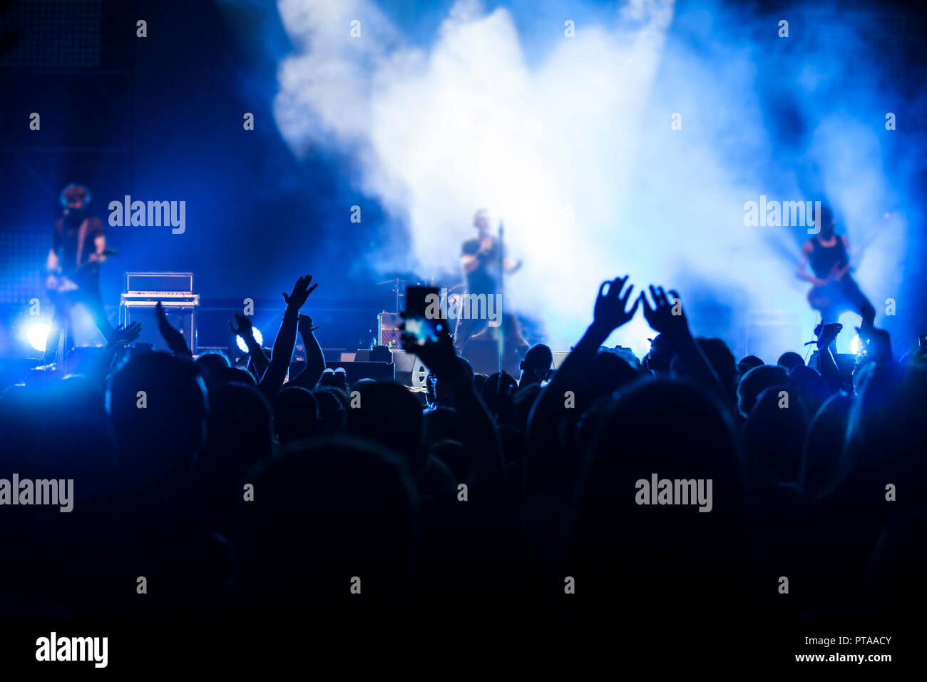 Crowd at concert - Cheering crowd in bright colorful stage lights Stock ...