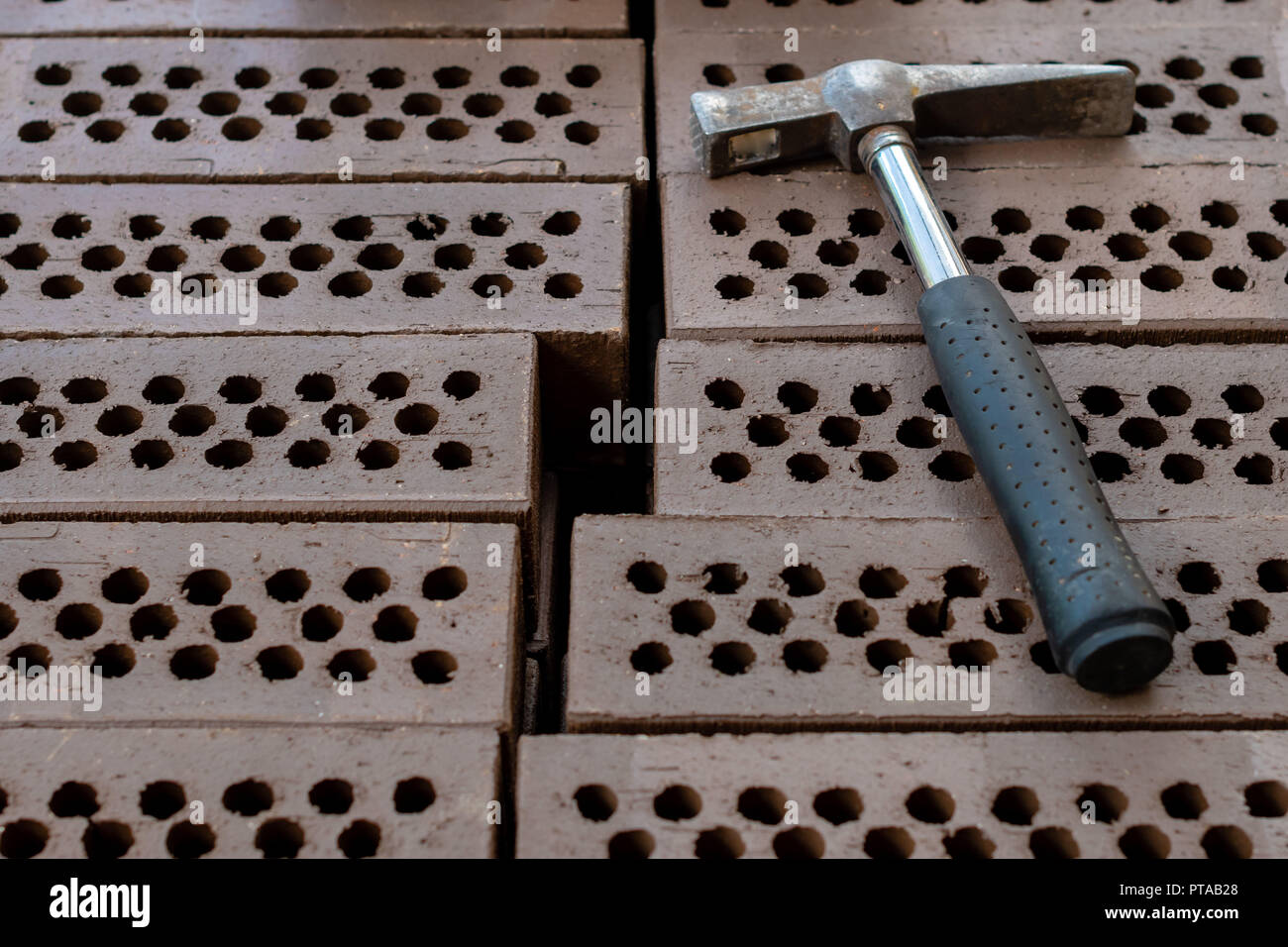 A hammer is laid on a red brick stack Stock Photo - Alamy