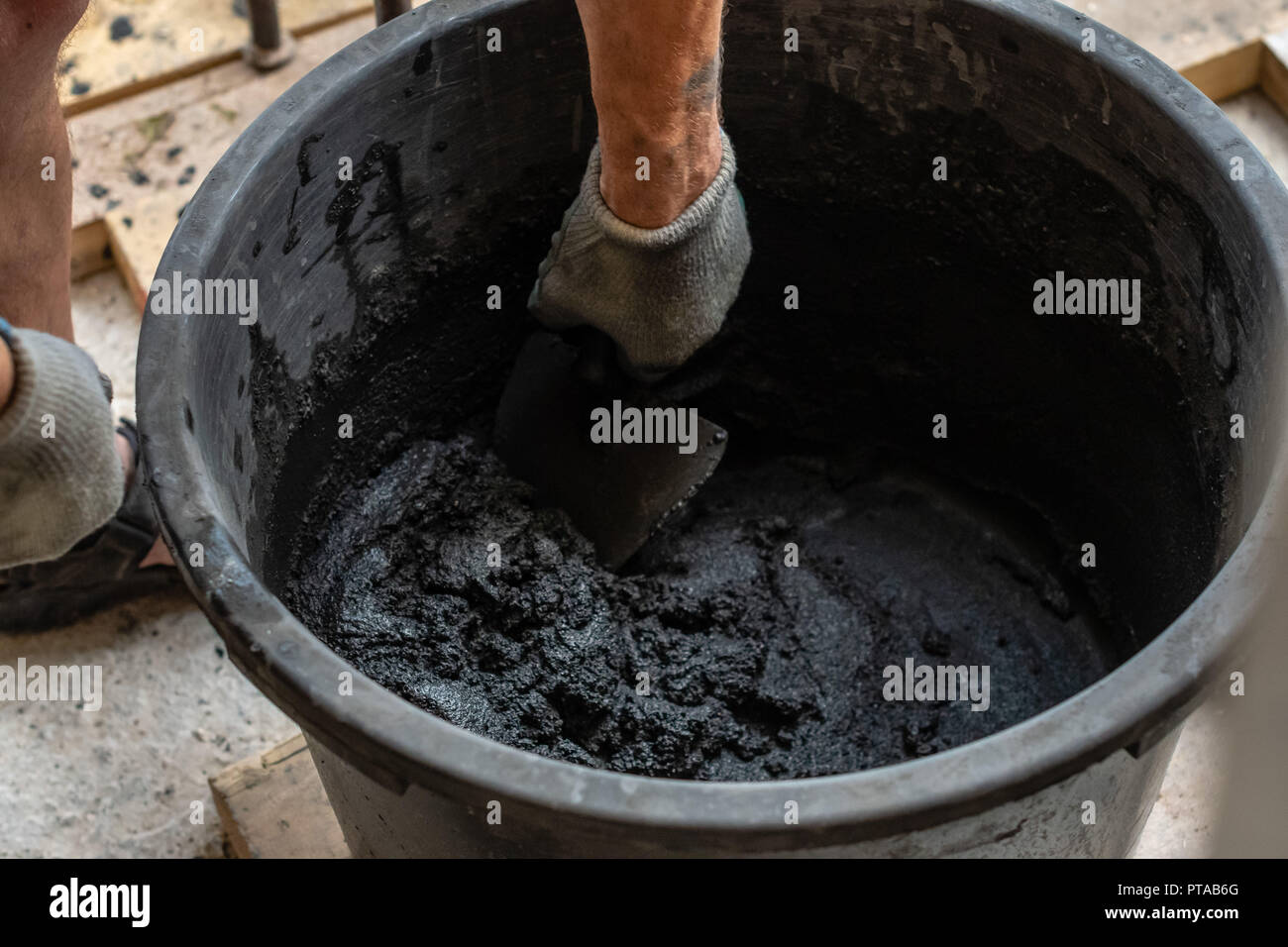 Mixing cement in a bucket hi-res stock photography and images - Alamy