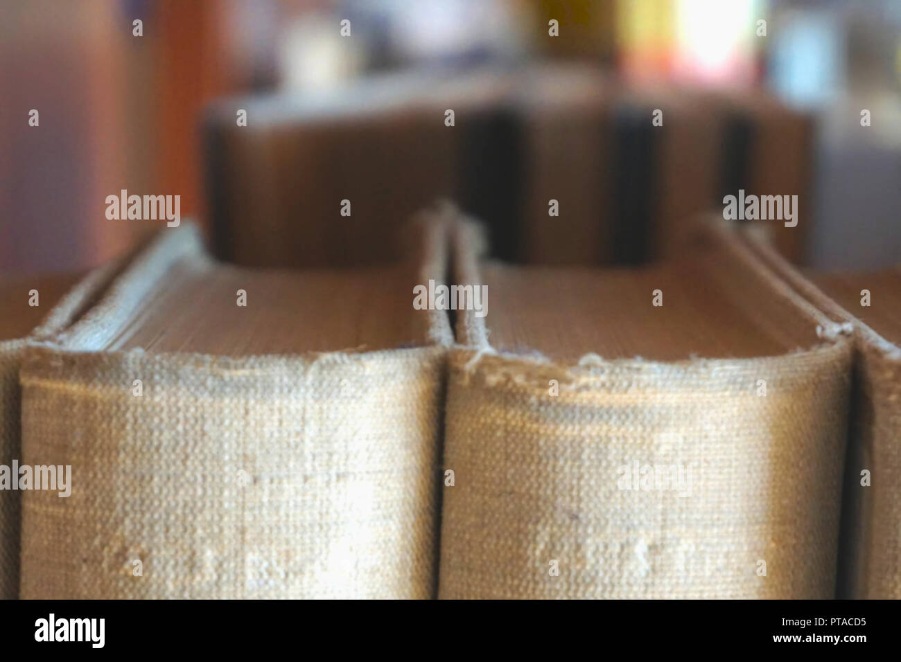 Old books with damage cover on the bookshelf in library, close up top ...