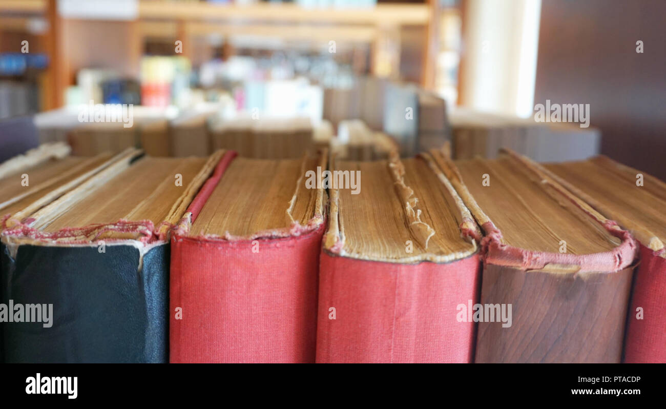 Old and damage different color books lined on the bookshelf in library ...