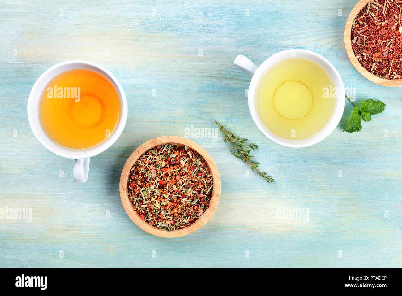 An overhead closeup photo of tea, on a teal background with copyspace ...