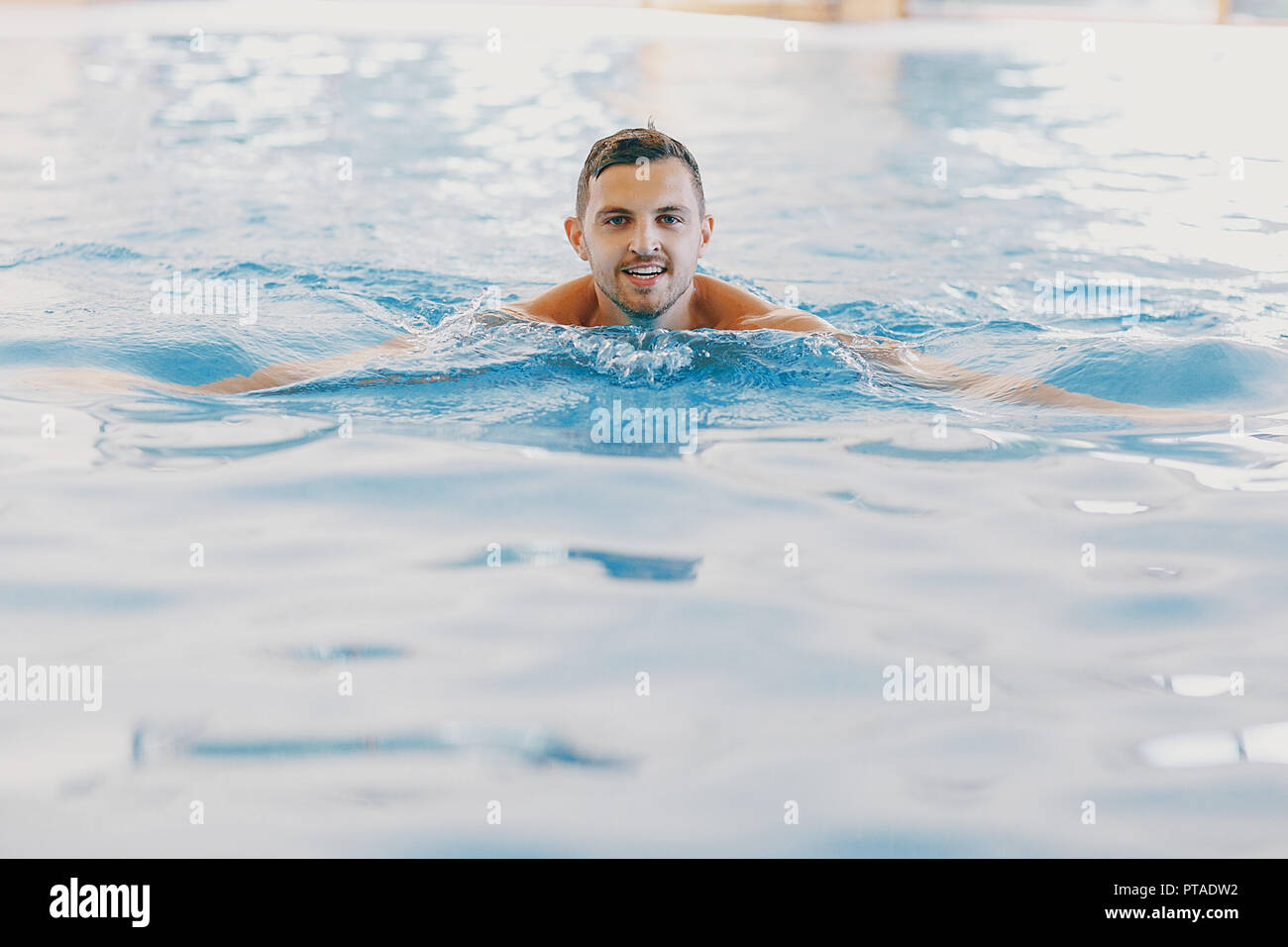A handsome man floating in a large pool at home Stock Photo - Alamy