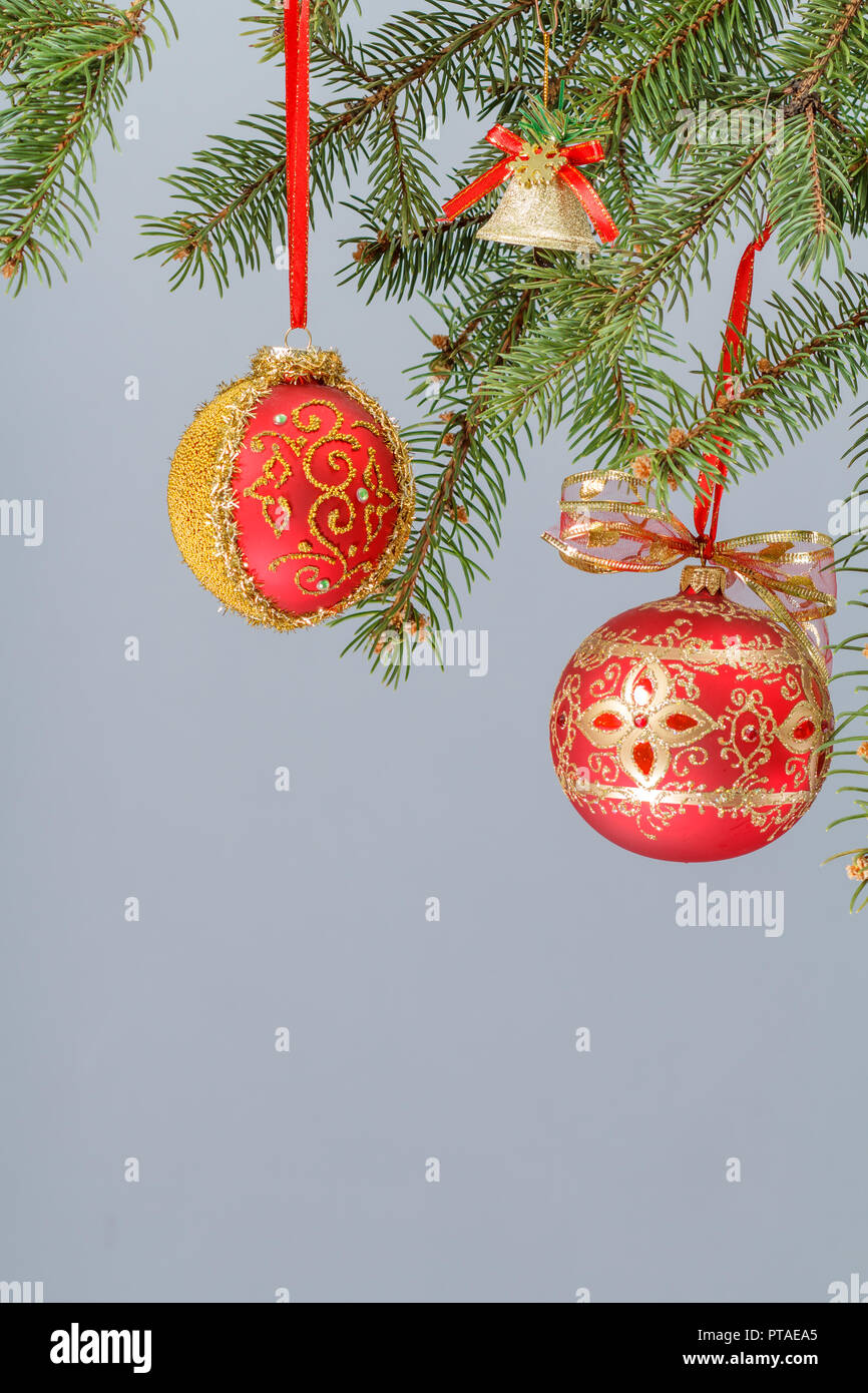 Branches of fir tree with balls, bell and other Christmas ornament on ...