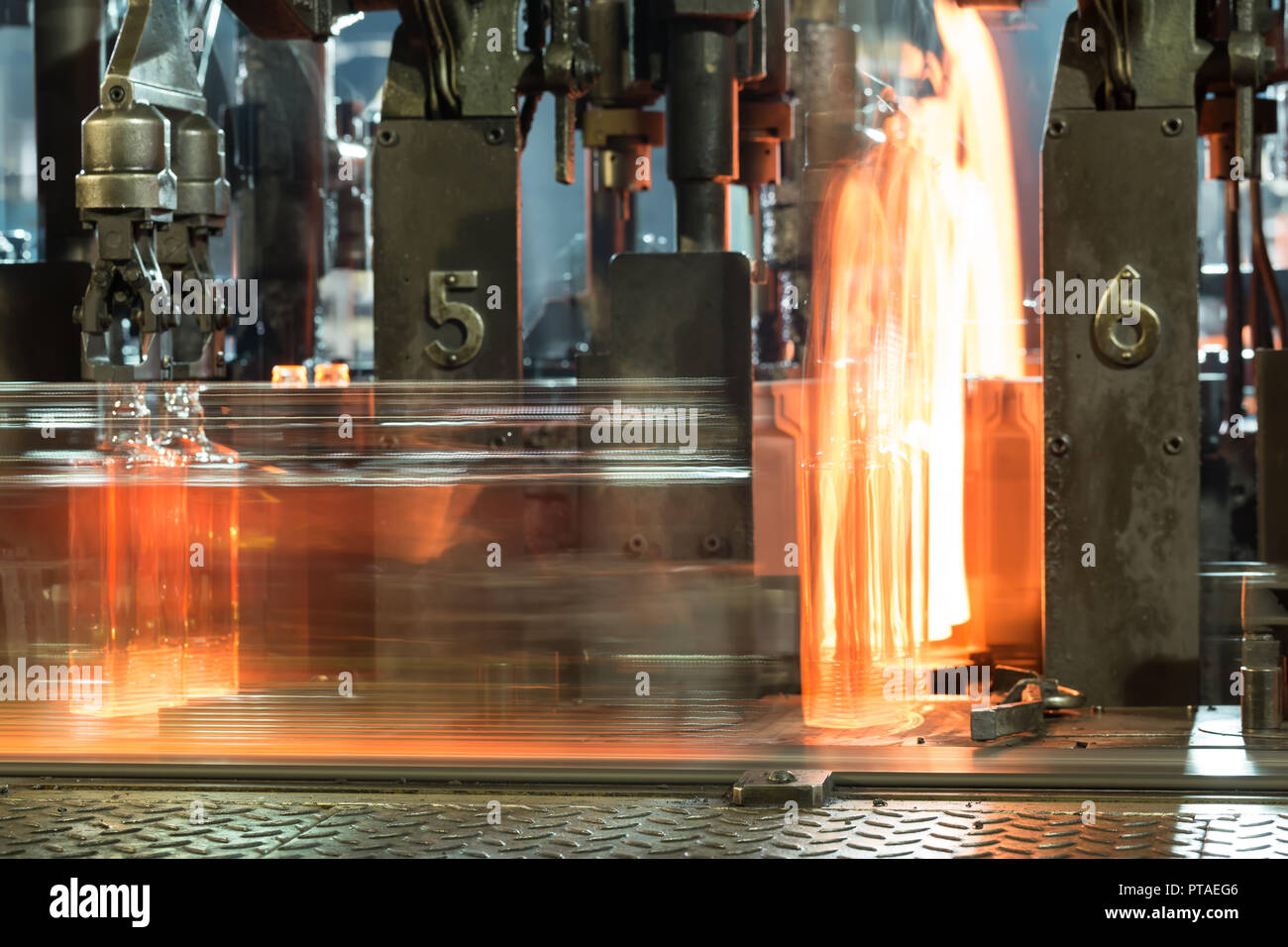 Process of movement of hot glass bottles on the conveyor. Hot red ...