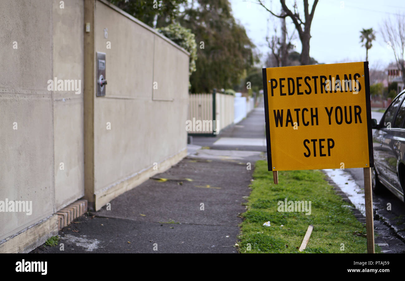 Pedestrian watch your step sign in yellow color Stock Photo - Alamy