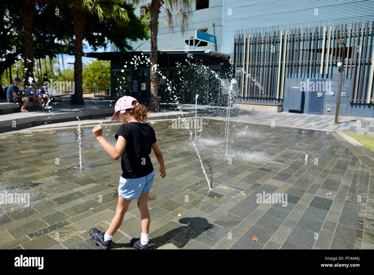 Girl playing in water jets hi-res stock photography and images - Alamy