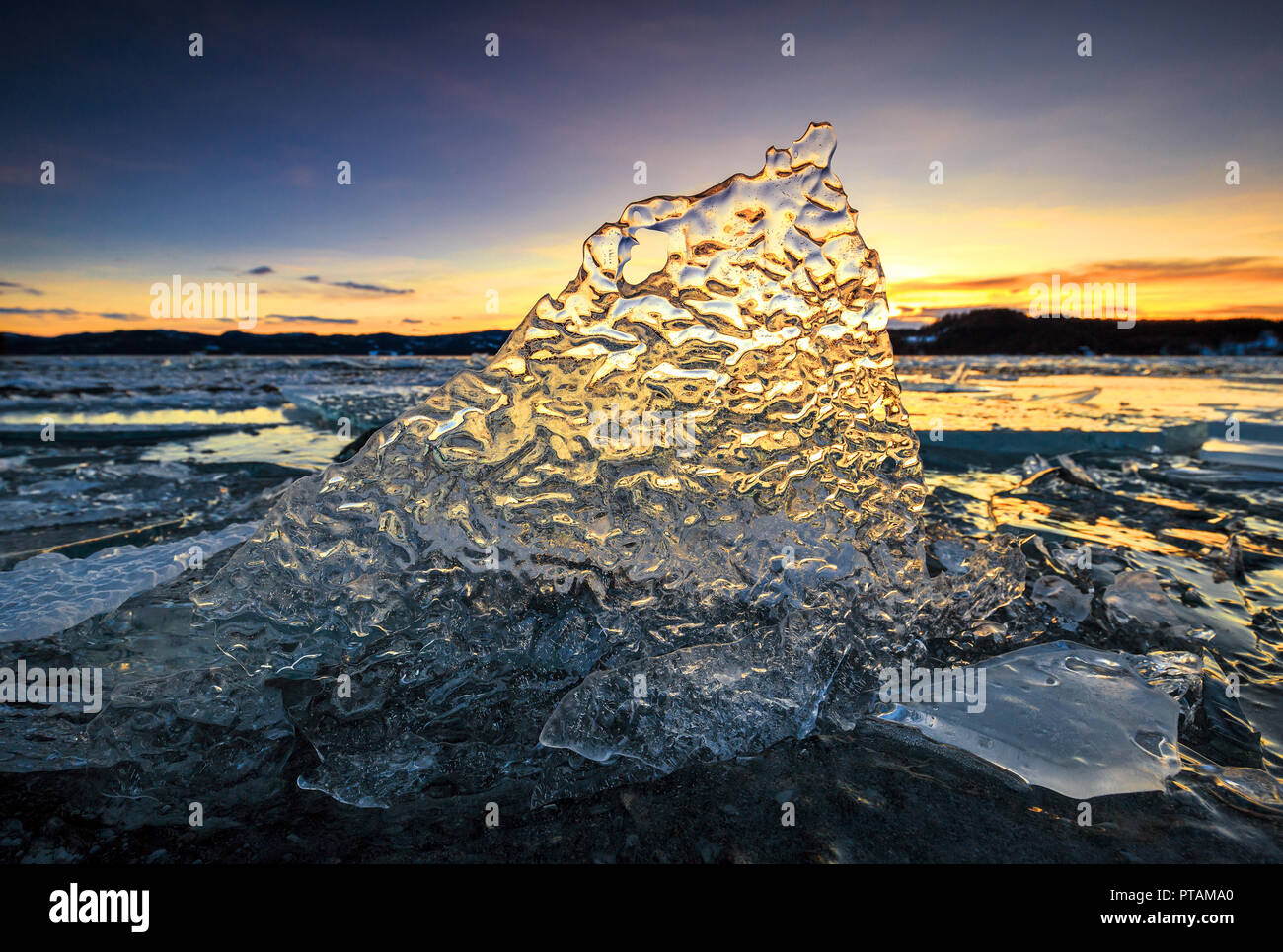 Ice floe on frozen lake Jonsvatnet, beautiful sunset time. Norway, area ...