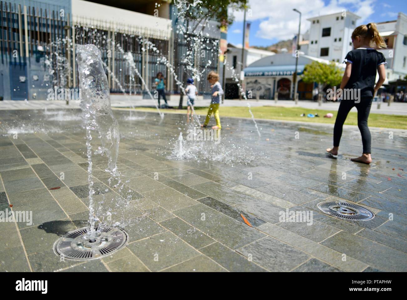 Girl playing in water jets hi-res stock photography and images - Alamy