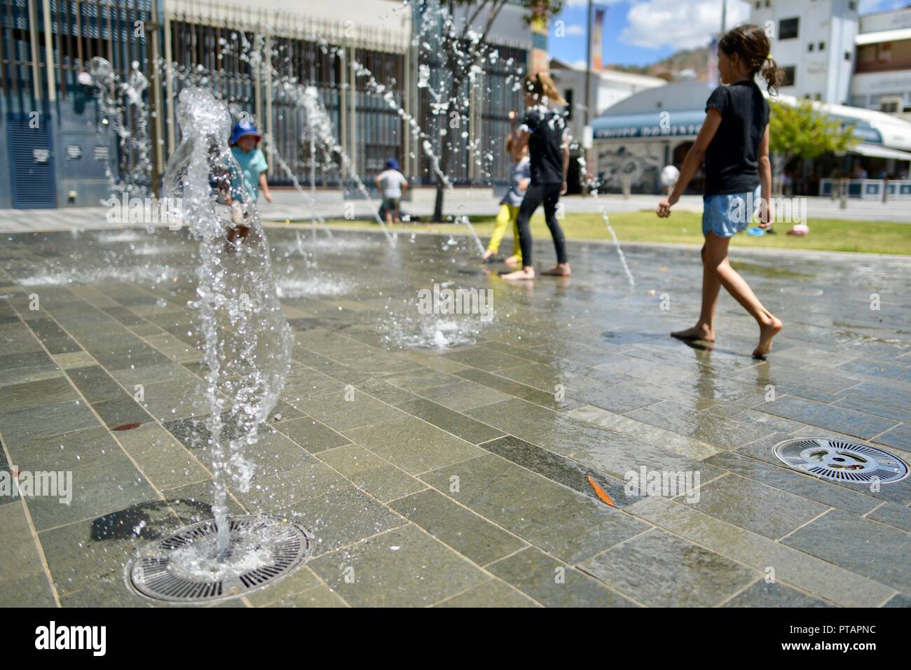 Girl playing in water jets hi-res stock photography and images - Alamy