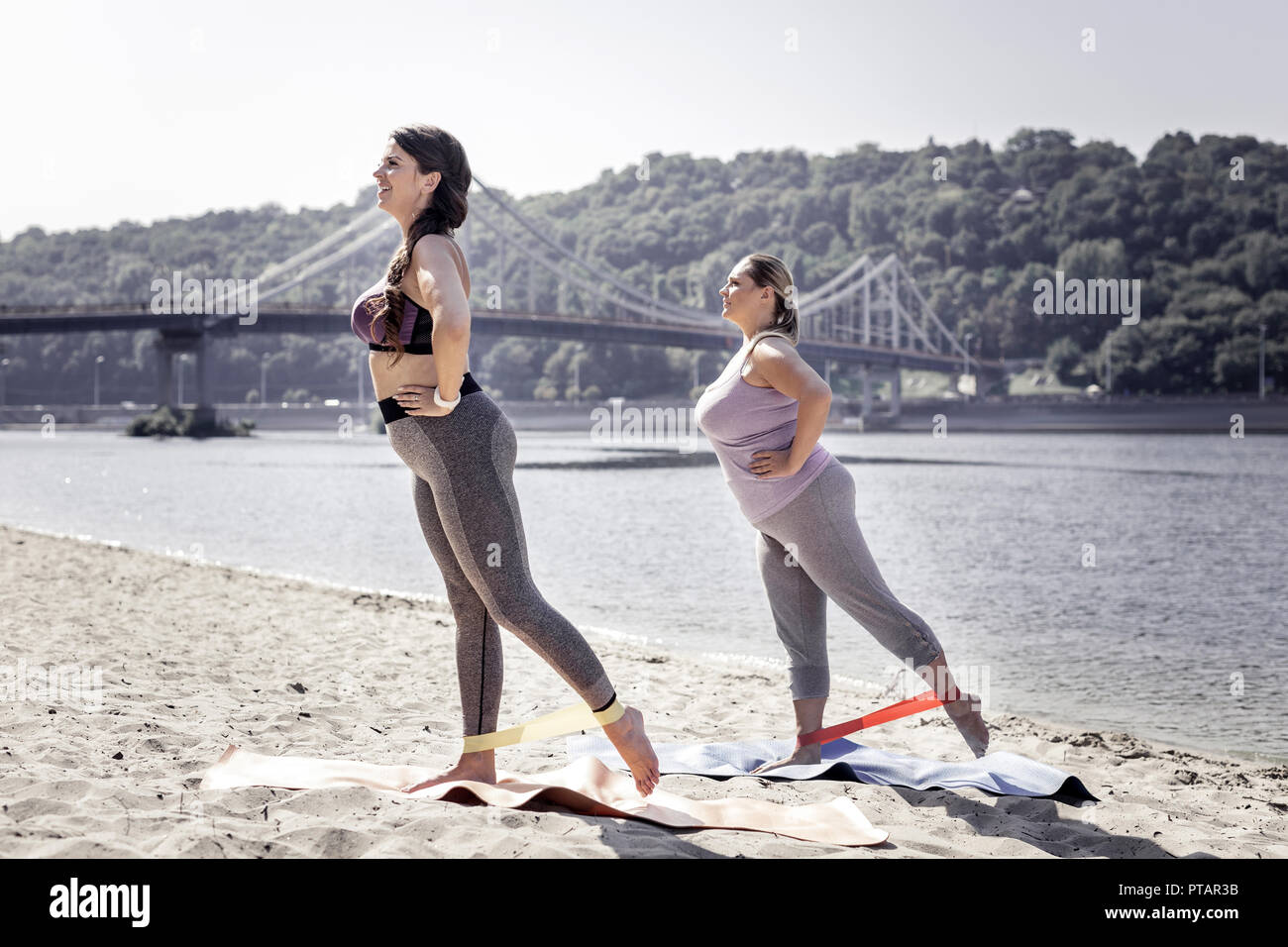 Nice young women doing an exercise together Stock Photo - Alamy