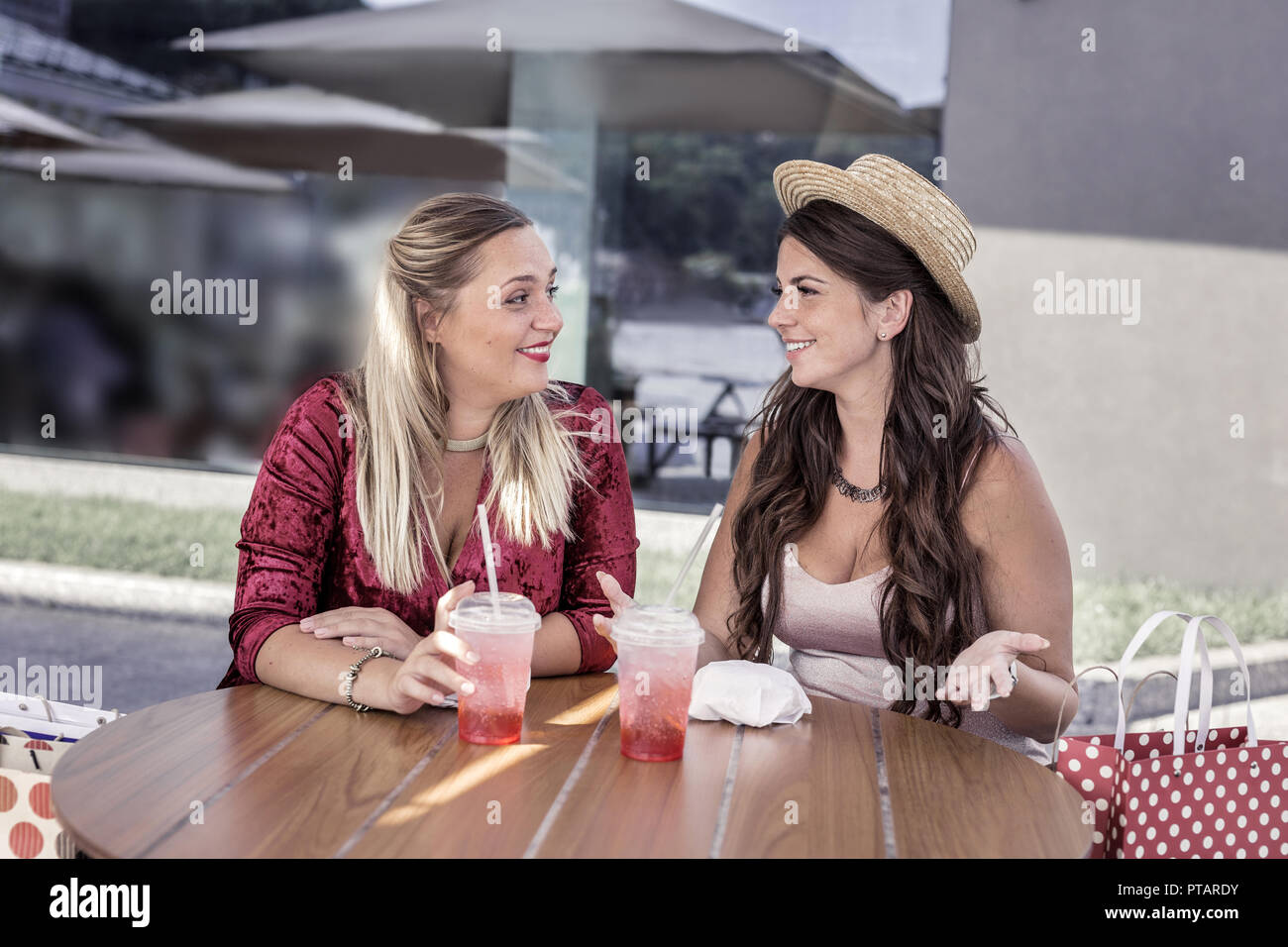 Happy delighted women sitting together at the table Stock Photo - Alamy