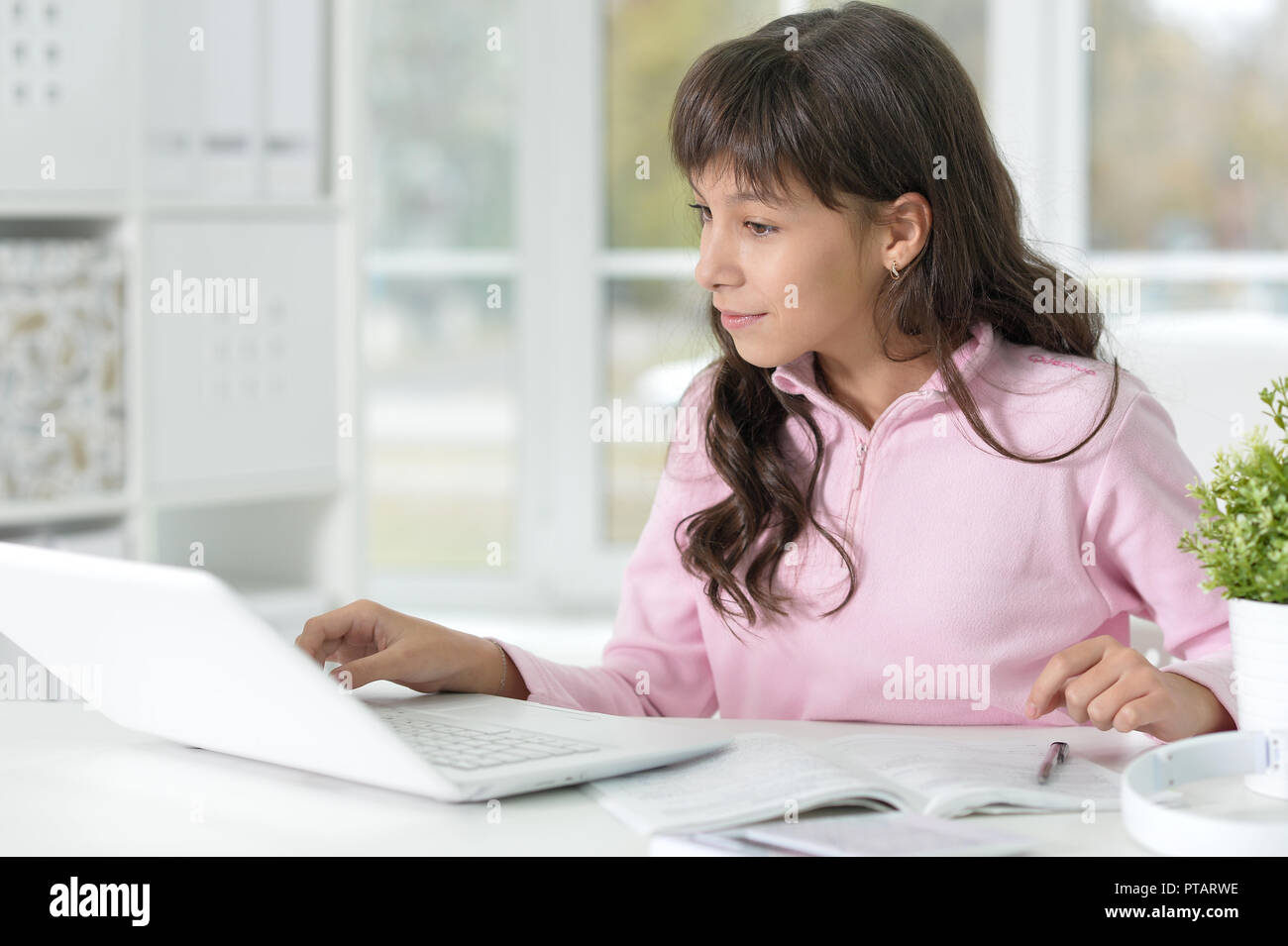 Portrait of beautiful girl with laptop studying at desk Stock Photo - Alamy