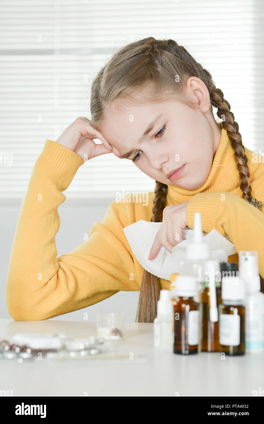 Portrait of a cute little girl taking medicine at home Stock Photo - Alamy